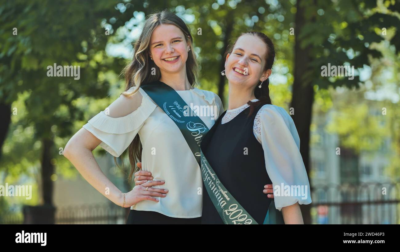 Portrait of two Russian schoolgirls graduating from high school with a ...
