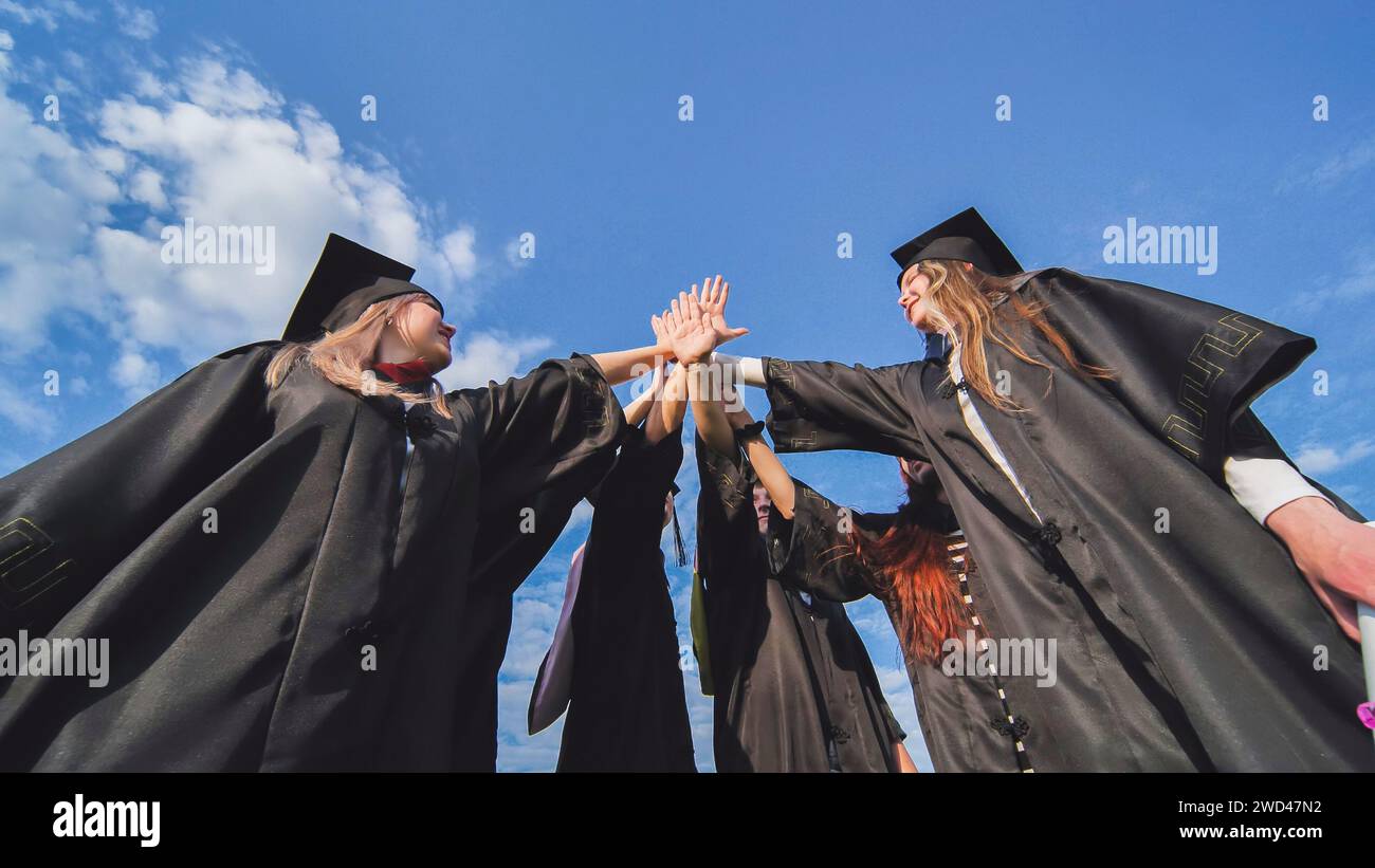Team of college or university students celebrating graduation. Group of ...