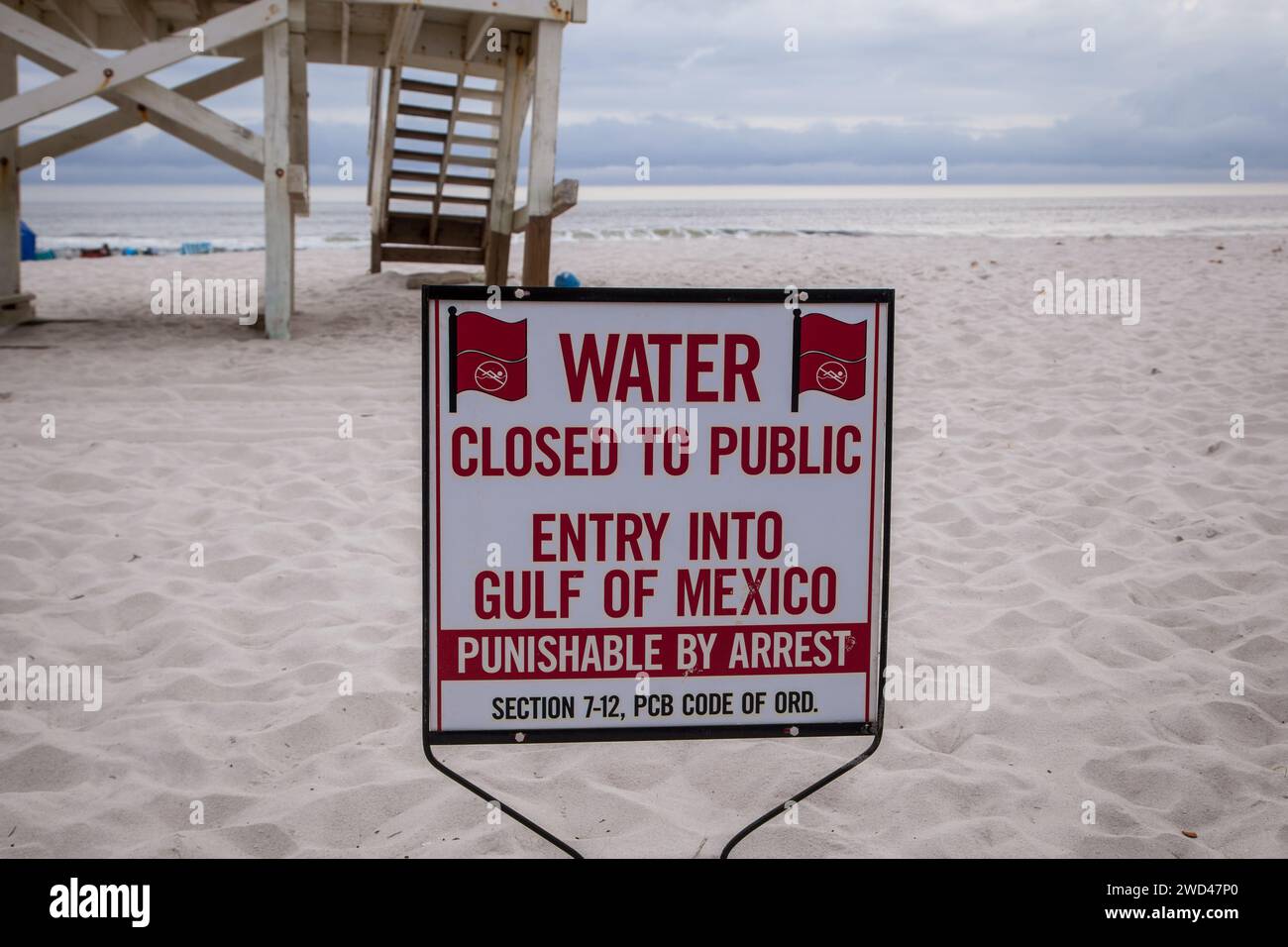 Waning sign on the beach in order to keep people safe Stock Photo - Alamy