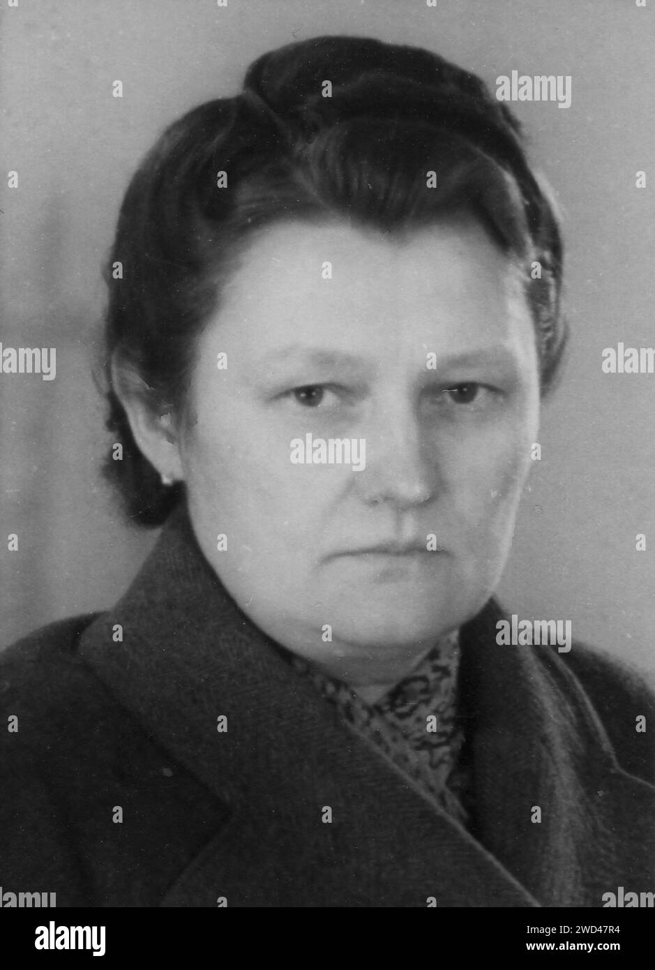 An antique photo shows a studio portrait of a middle-aged woman in a ...