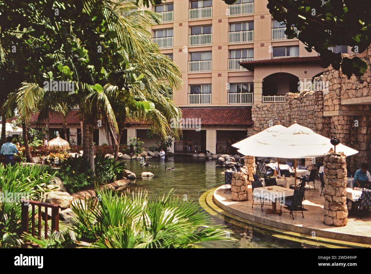 Open air dining area overlooking a lagoon pool at the Aruba Hyatt ...