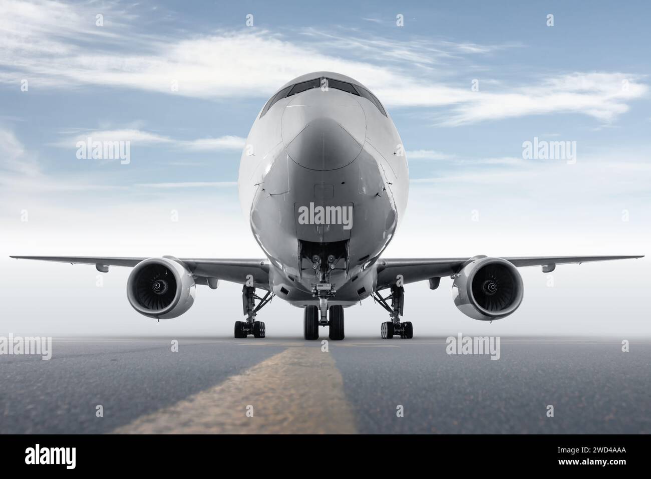 Front view of wide body passenger airplane isolated on bright ...
