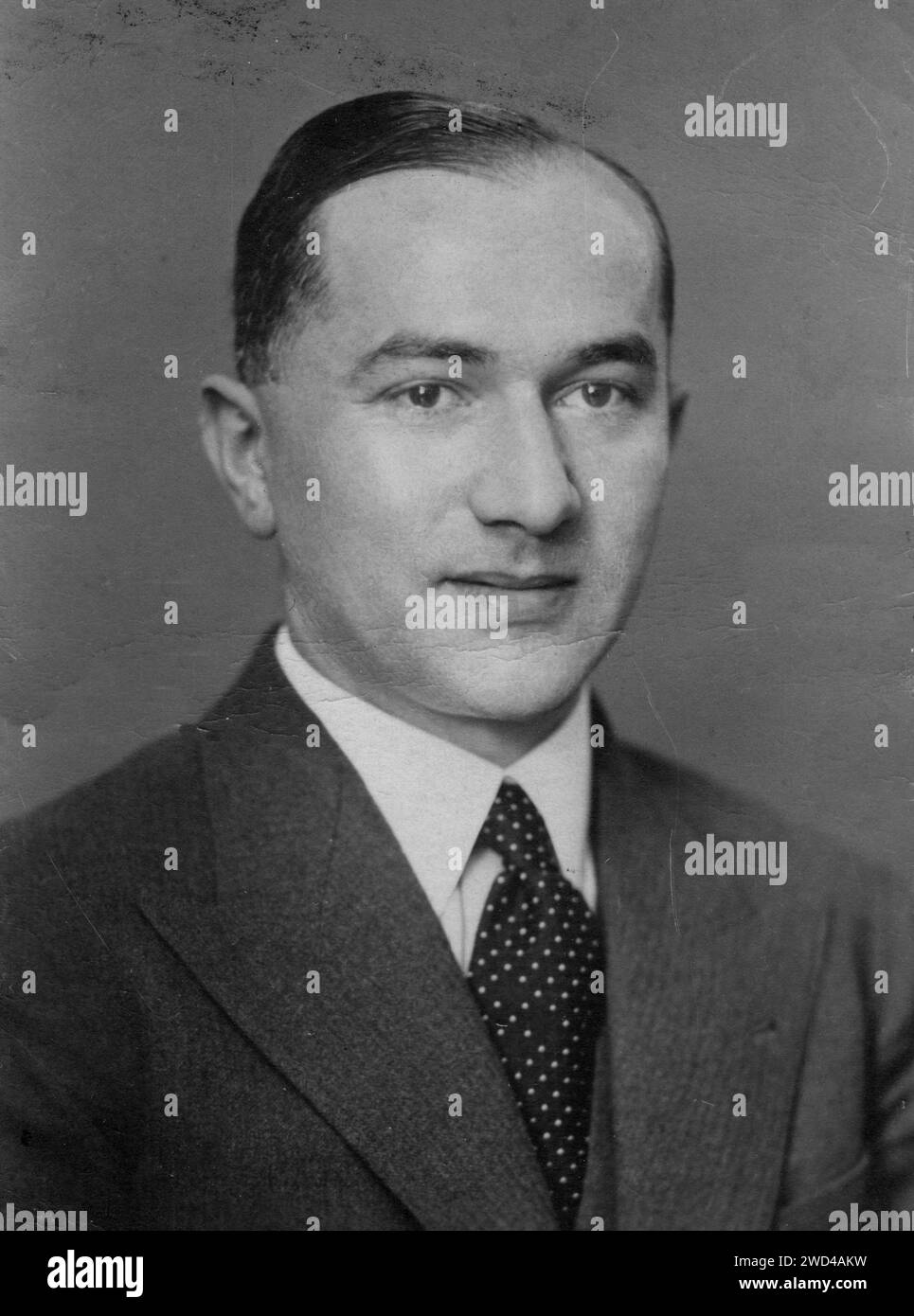 Antique photo studio portrait of a Caucasian man in a formal suit ...