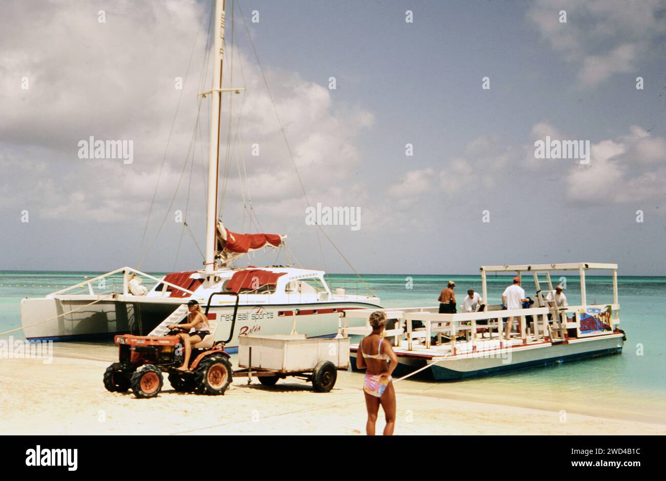 Tourists in a beach area with catamaran and dive boat at the Hyatt ...