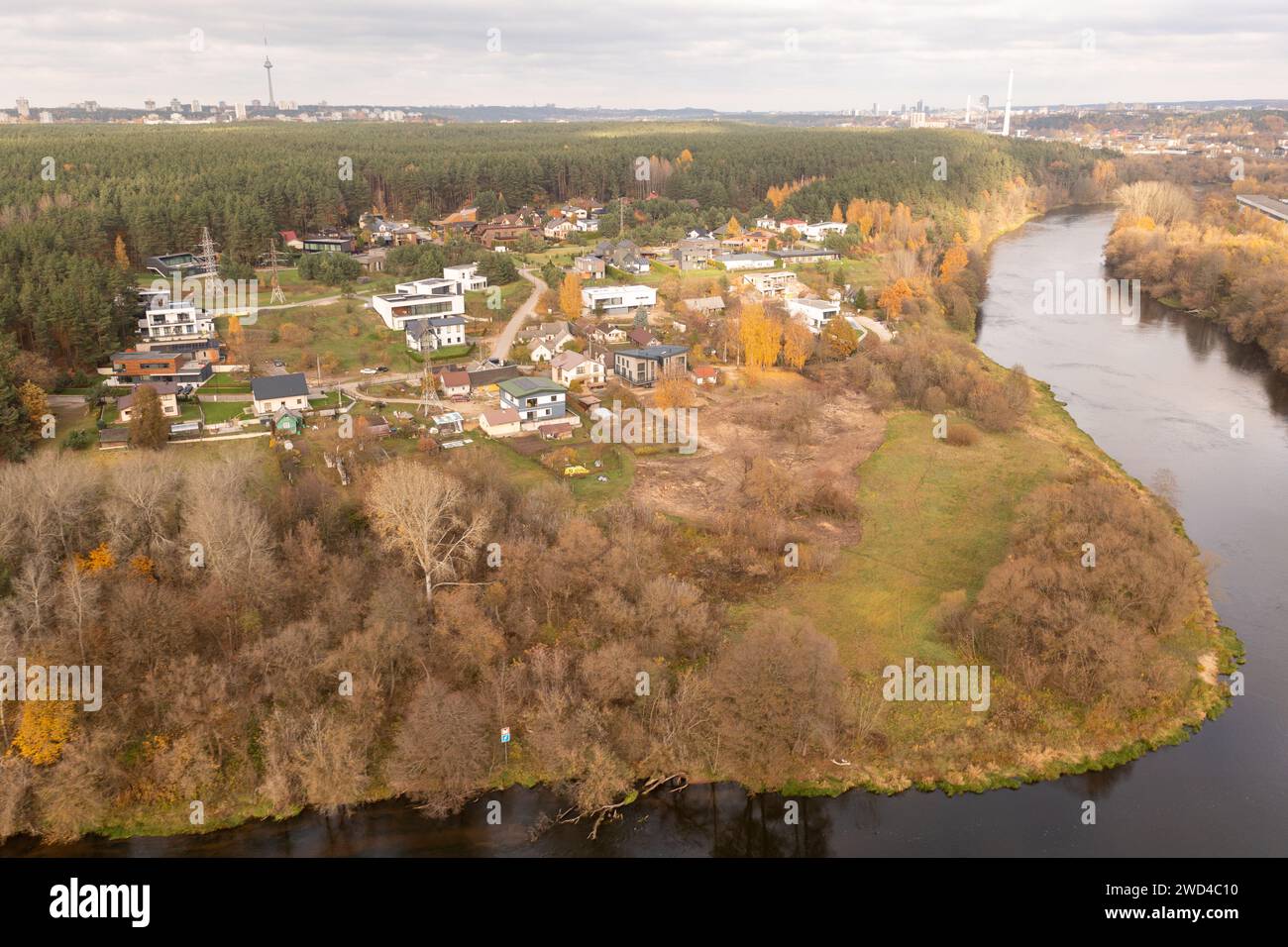 Drone photography of small house community in a forest near a river and ...