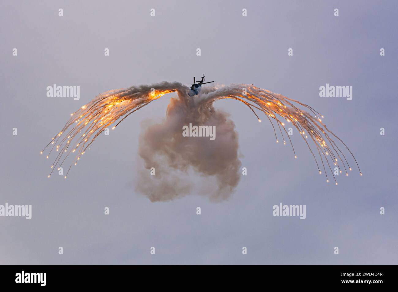 Helicopter deploying flares and chaff- (NH90 military helicopter) a ...