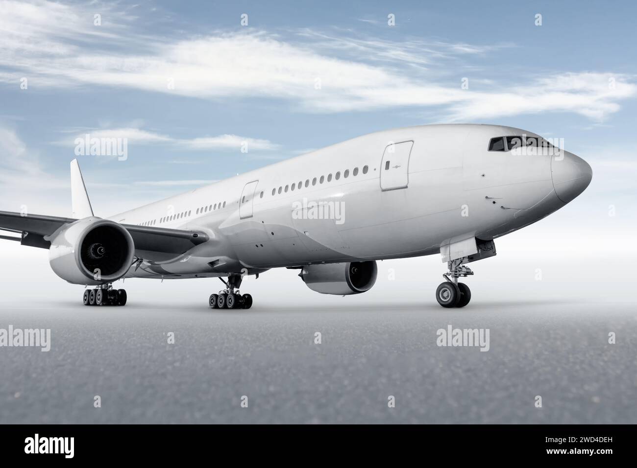 Wide body passenger aircraft isolated on bright background with sky ...