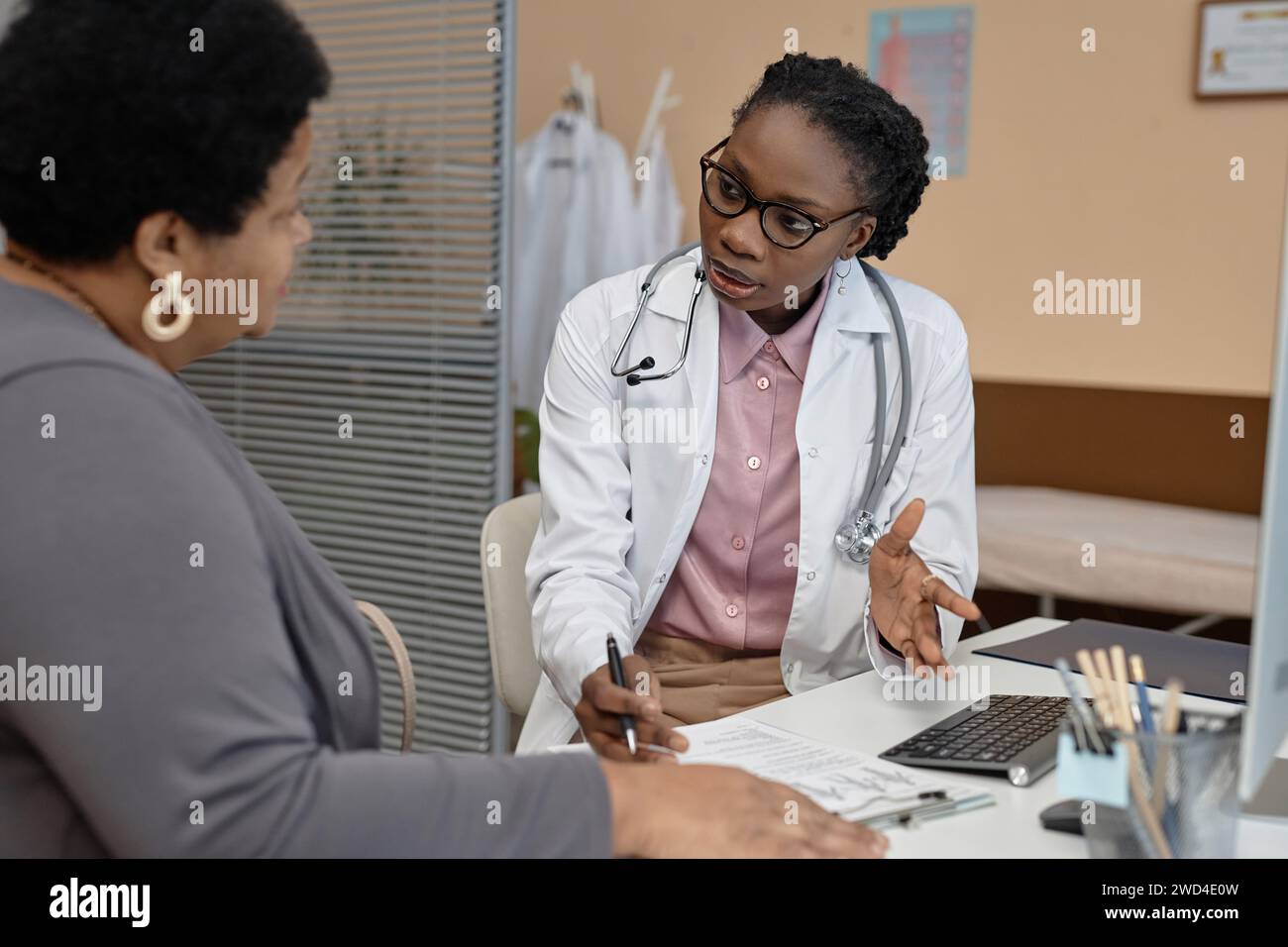 Female Doctor Talking to Patient during Visit Stock Photo - Alamy
