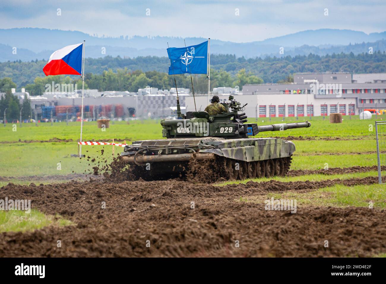T72 Tank (M4 CZ Variant number 029) driving on a muddy field in front ...