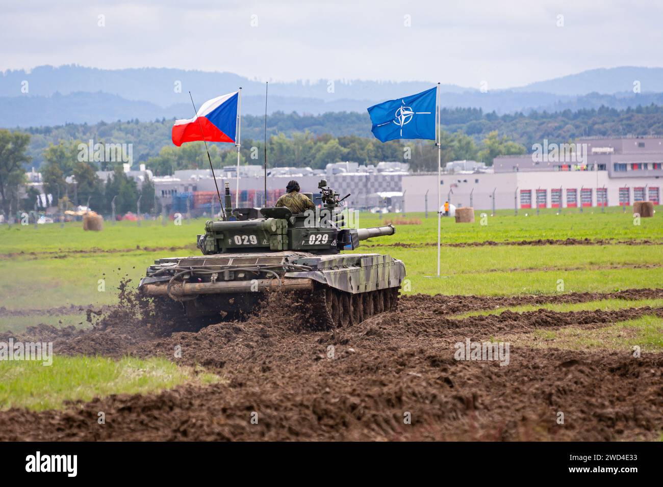 T72 Tank (M4 CZ Variant number 029) driving on a muddy field in front ...