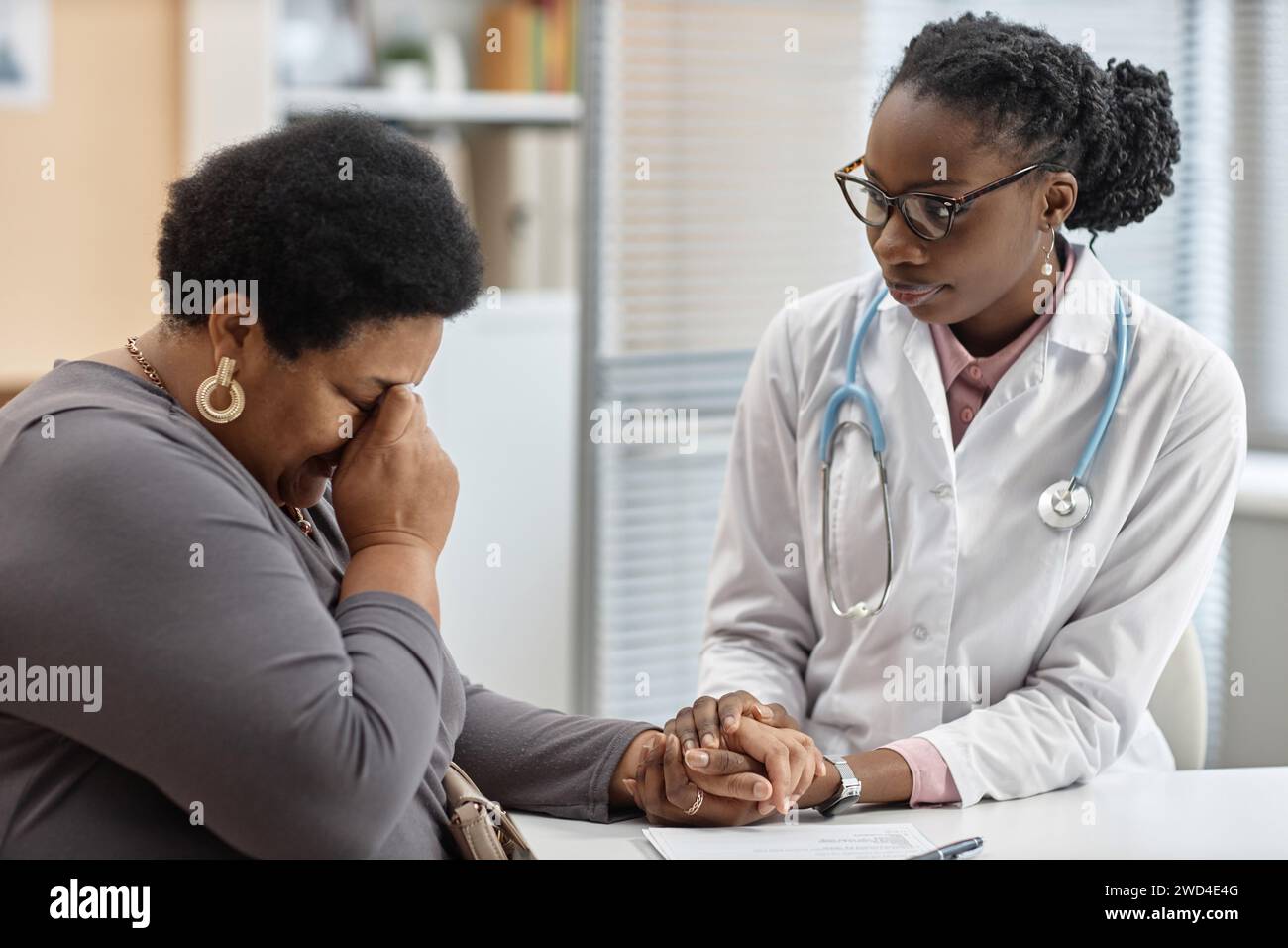 Female General Practitioner Consoling Crying Patient Stock Photo - Alamy
