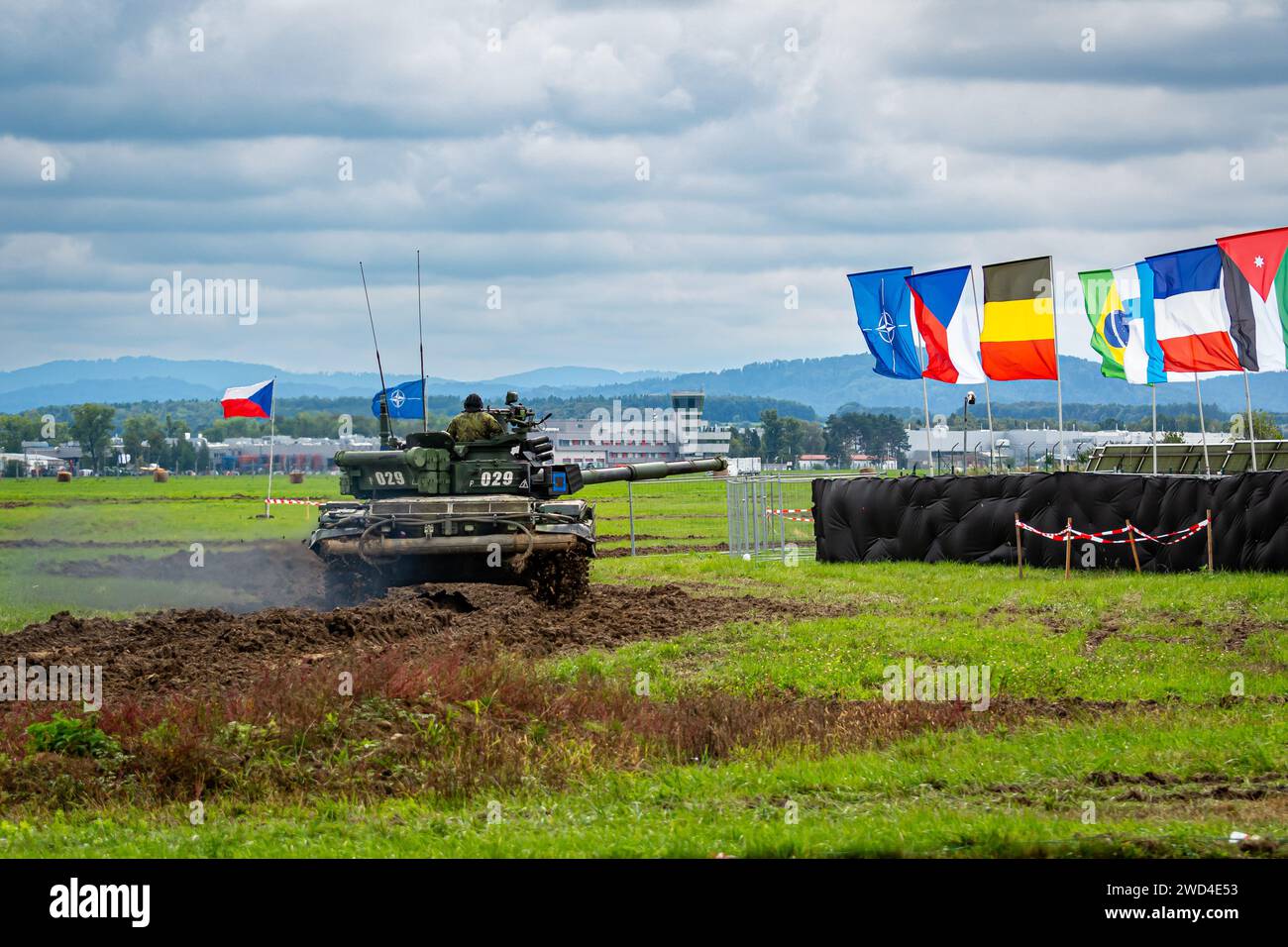 T72 Tank (M4 CZ Variant number 029) driving on a muddy field in front ...