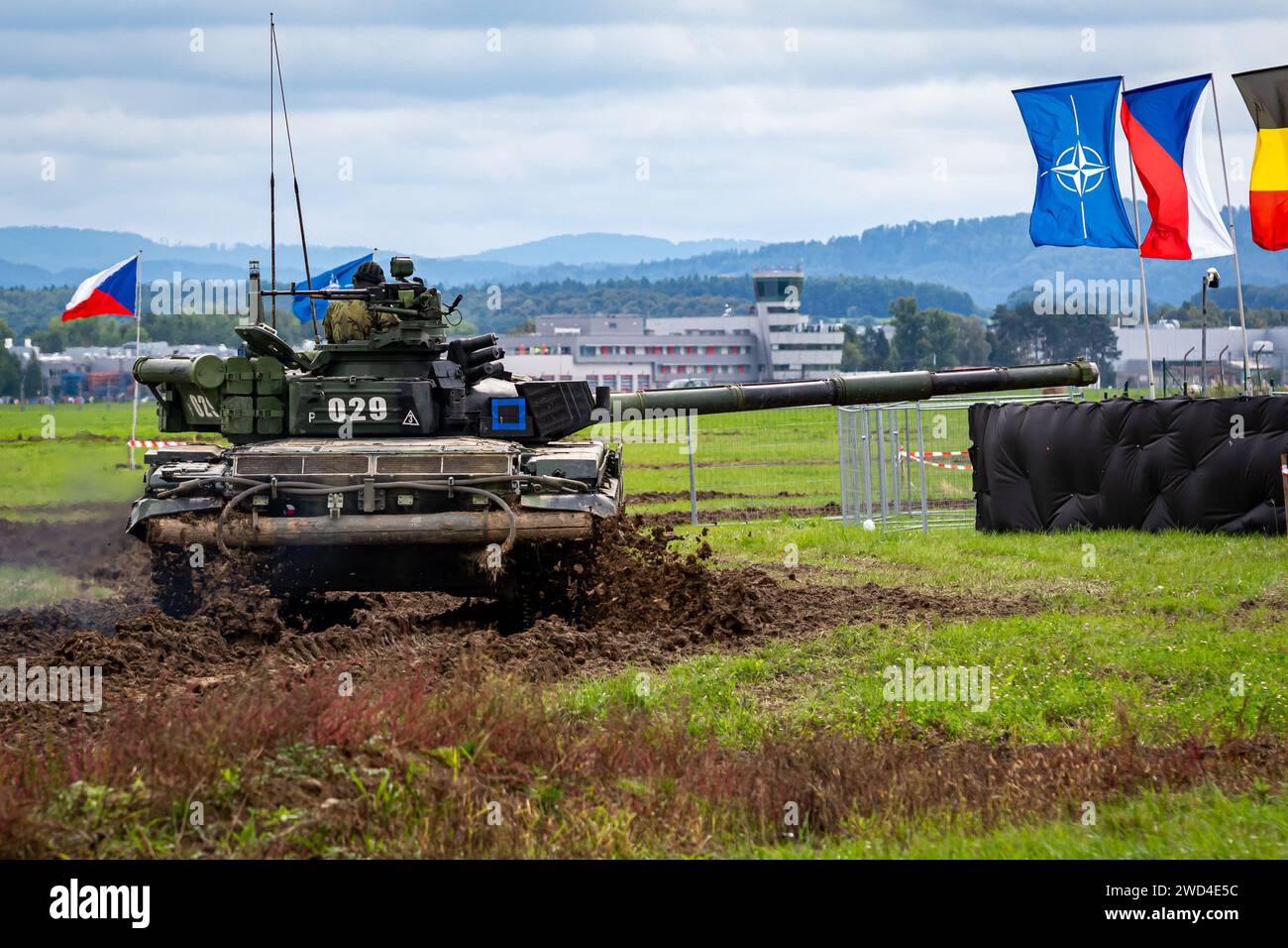T72 Tank (M4 CZ Variant number 029) driving on a muddy field in front ...