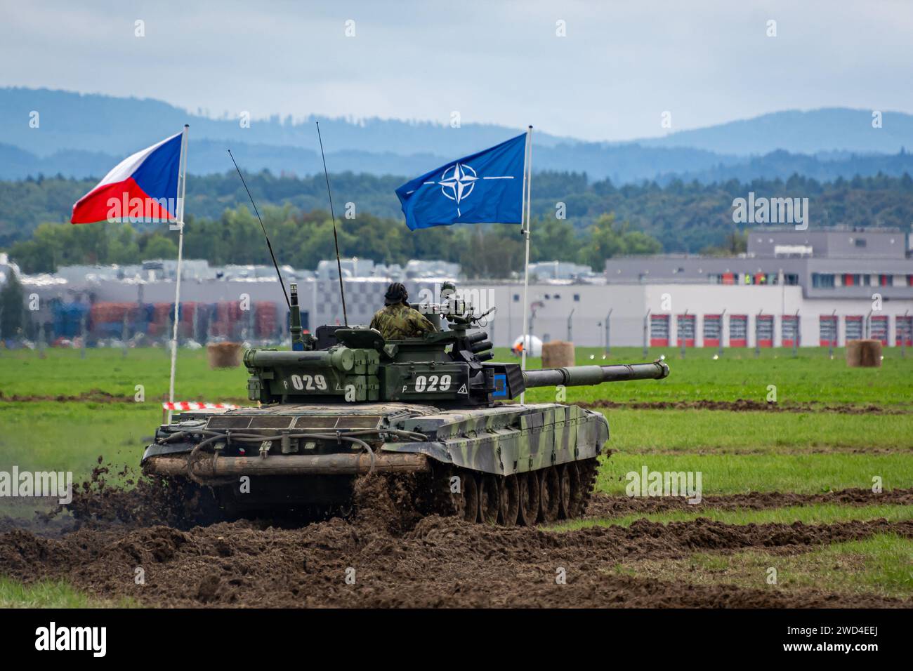 T72 Tank (M4 CZ Variant number 029) driving on a muddy field in front ...