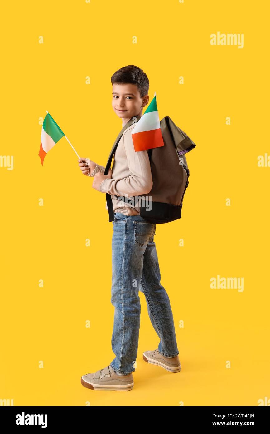 Little boy with backpack and flags of Italy on yellow background Stock ...