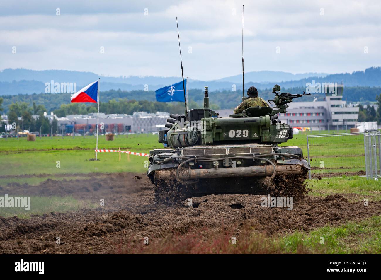 T72 Tank (M4 CZ Variant number 029) driving on a muddy field in front ...