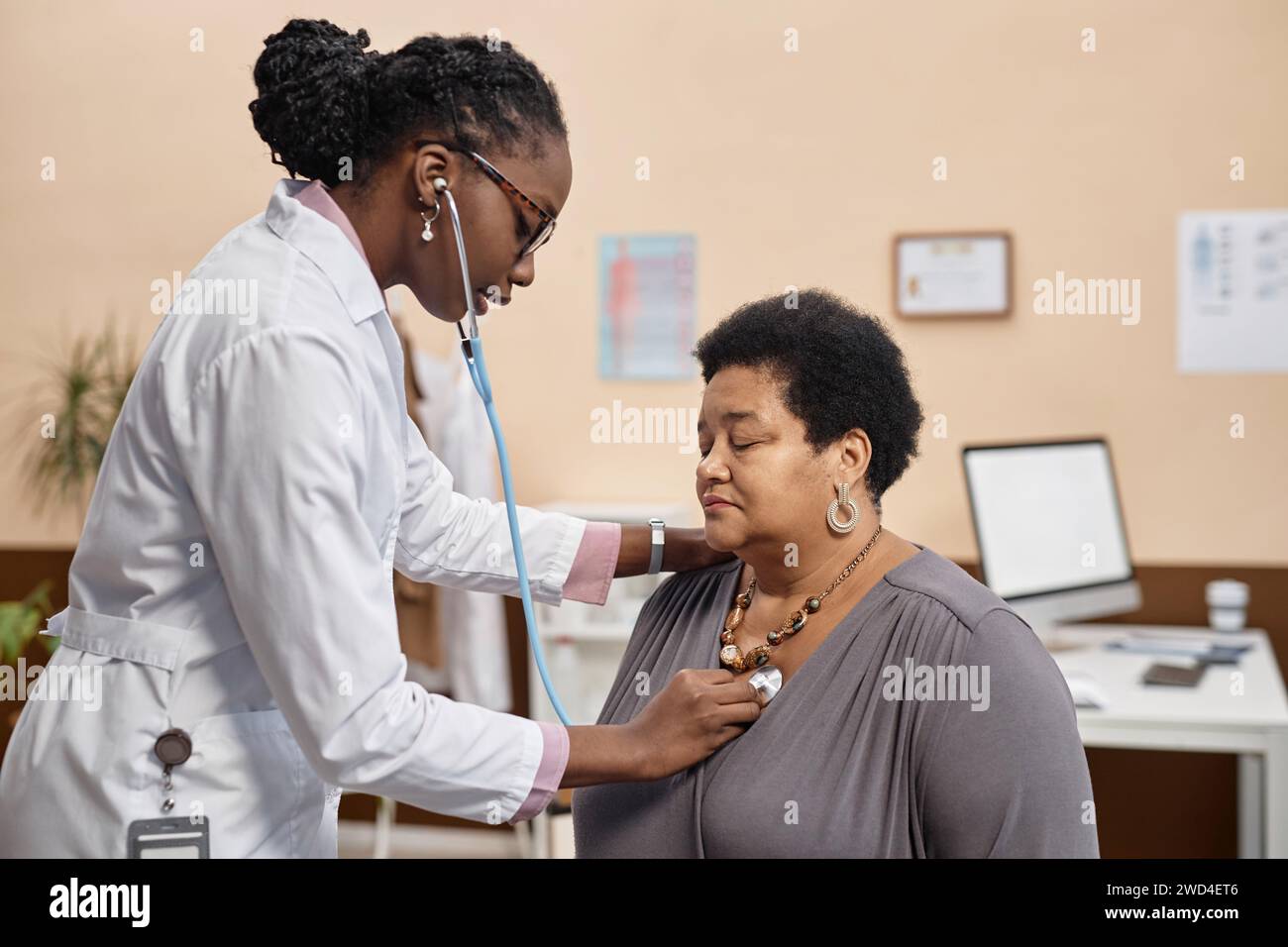 Female Health Practitioner with Patient Using Stethoscope Stock Photo ...