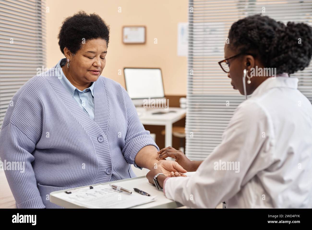 Mature Female Patient with Doctor Checking Pulse Stock Photo - Alamy