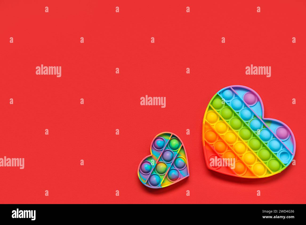 Heart-shaped pop it fidget toys on red background. Valentine's day ...
