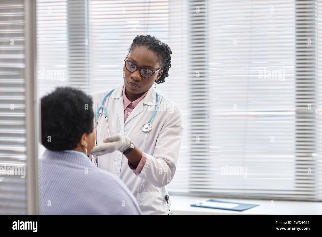 Woman Physician Conducting Medical Examination Stock Photo - Alamy