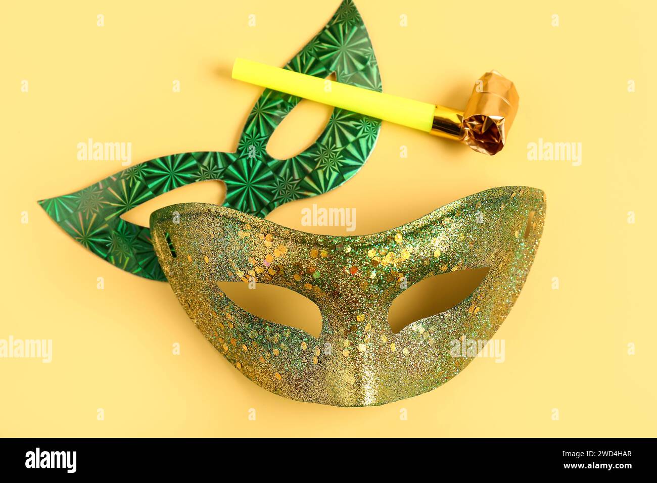 Carnival masks with party horn for Mardi Gras celebration on yellow ...