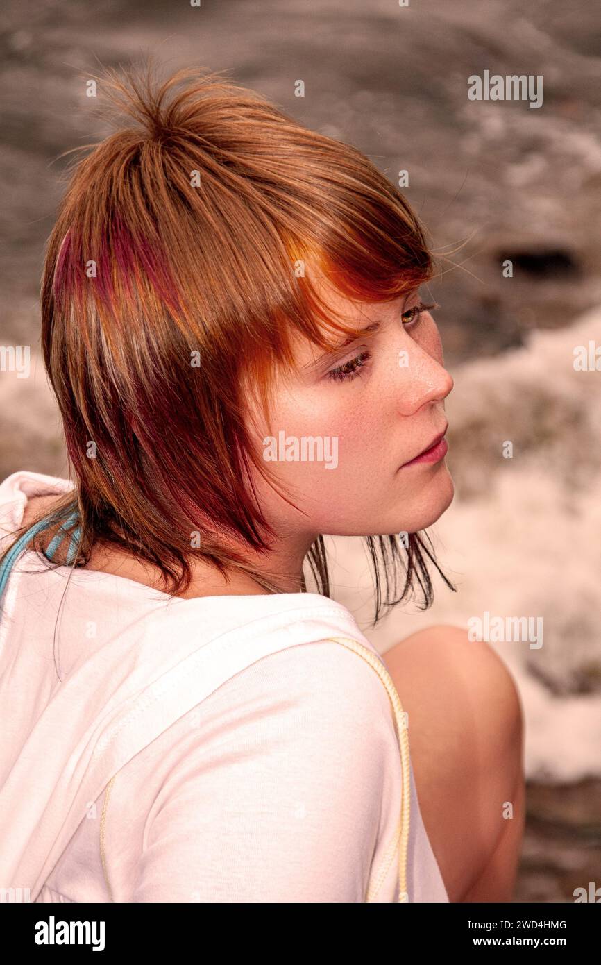 A woman sitting beside rocks at Broughty Ferry beach on Dundee ...