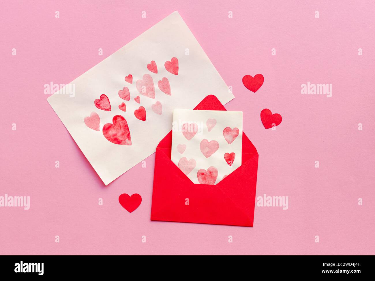 Envelope with heart-shaped design beside a pink card Stock Photo - Alamy