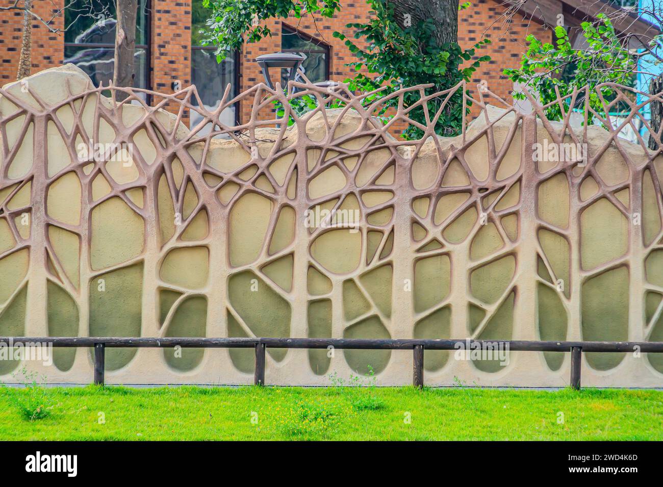 a concrete fence made to look like an artificial forest. Texture of ...