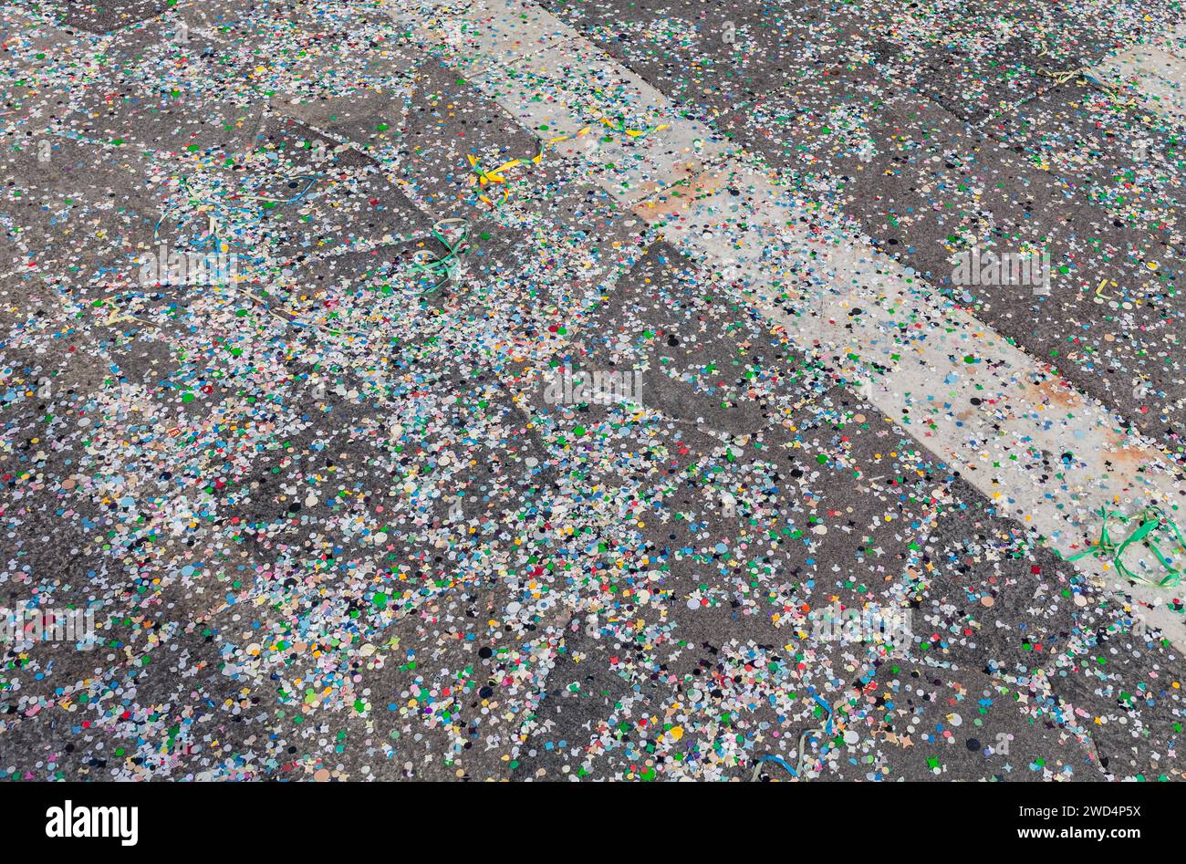 Colorful confetti on carnival fallen on street after celebrations Stock ...