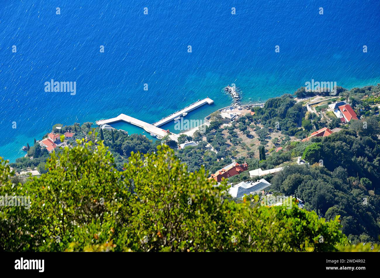 A serene beach perched on a hillside overlooking the ocean, complete ...