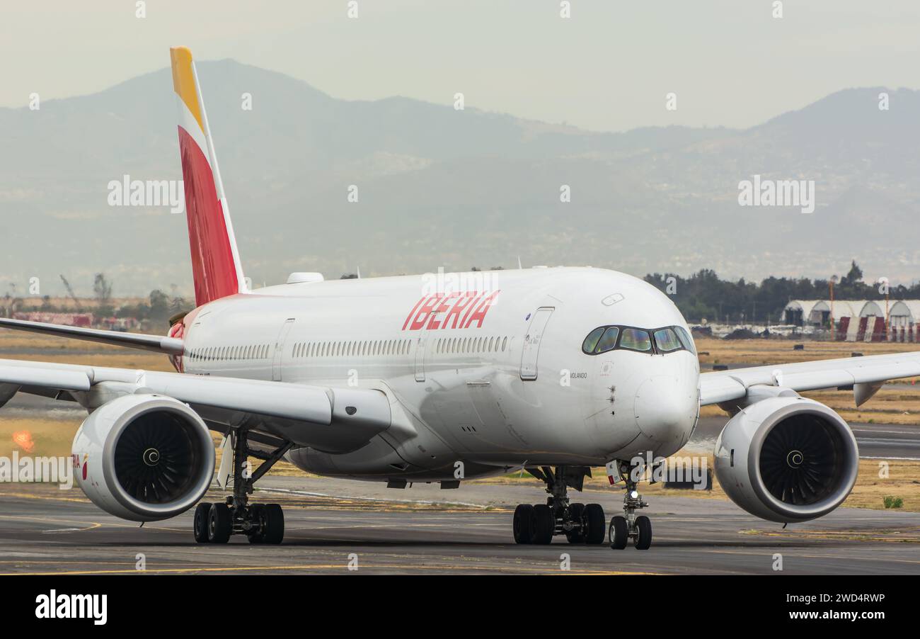 Airplane on runway with scenic hills in backdrop Stock Photo - Alamy