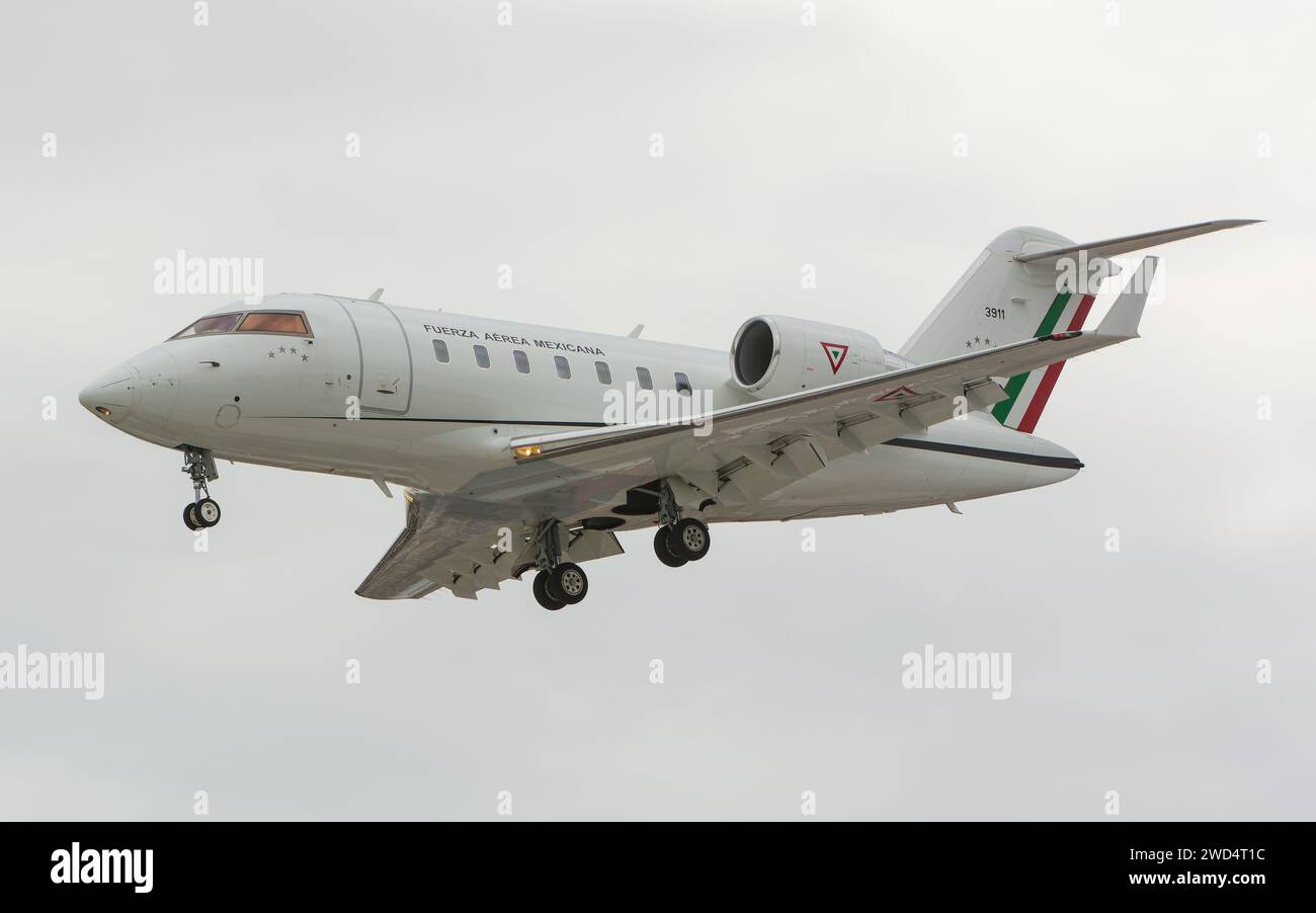 A small white aircraft soars amidst a cloudy gray sky Stock Photo - Alamy