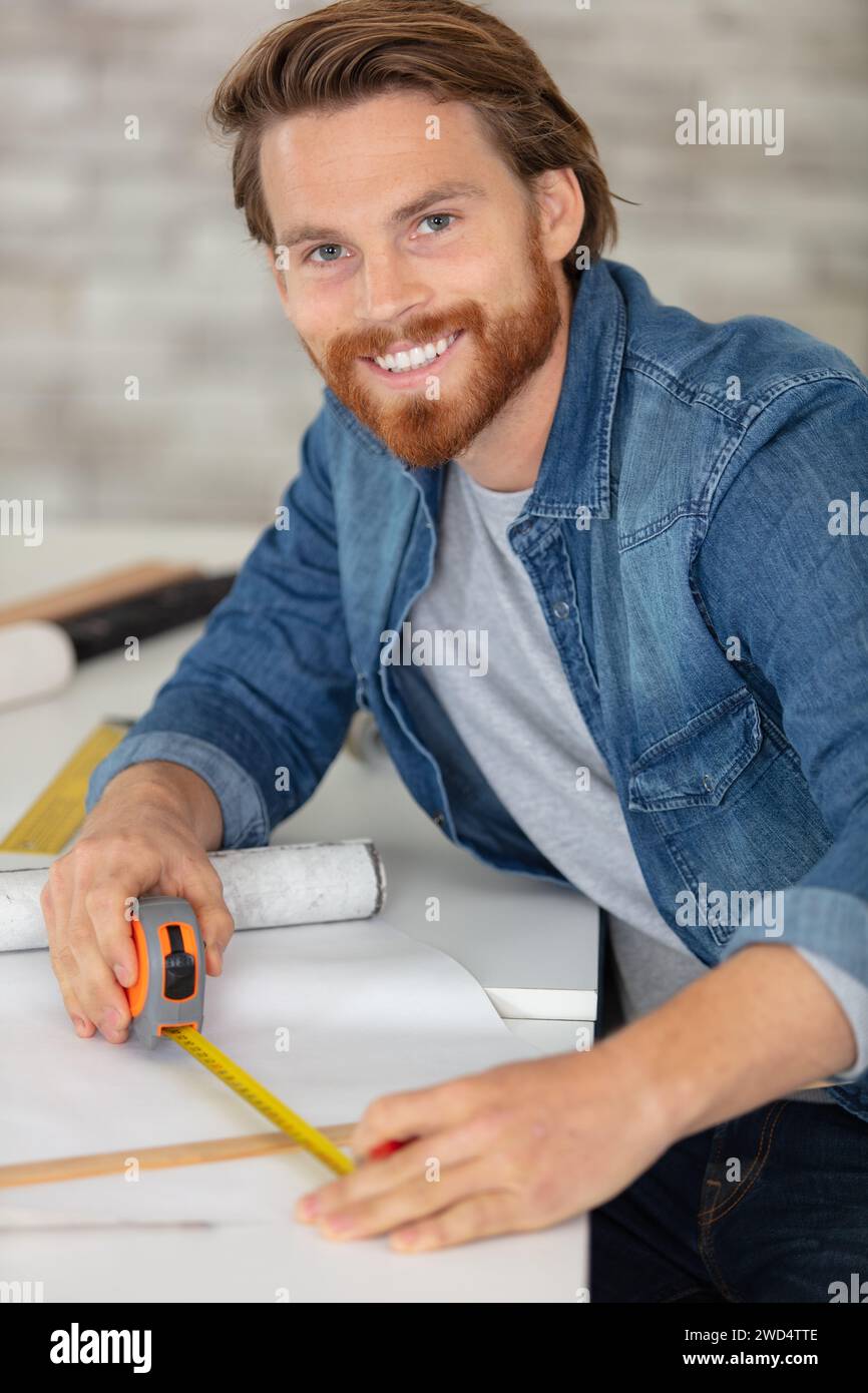 Man using tape to measure cabinet hi-res stock photography and images ...