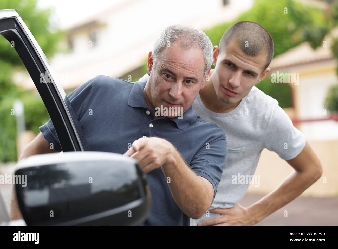 man pointing at rear view mirror Stock Photo - Alamy