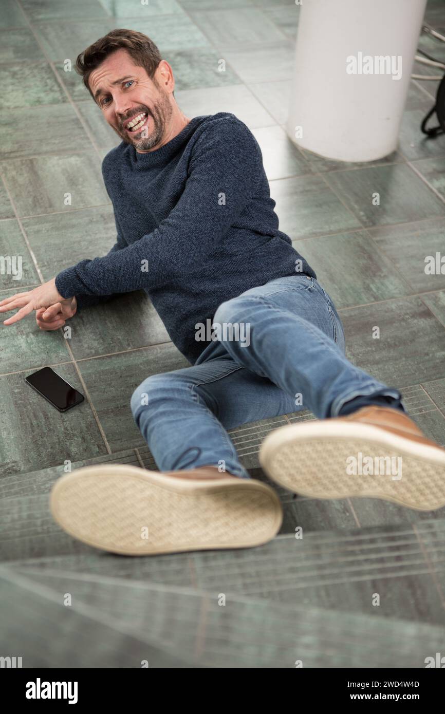 mature man lying on staircase after slip and fall accident Stock Photo ...