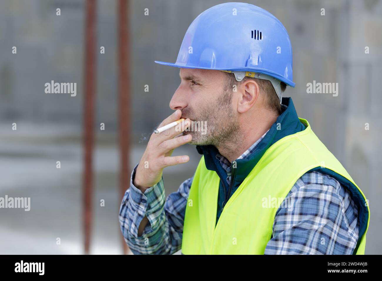male worker smoking a cigarette Stock Photo - Alamy