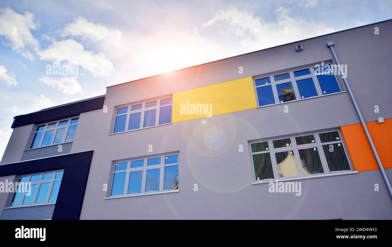 Multi-colored facades of the school with white window frames Stock ...
