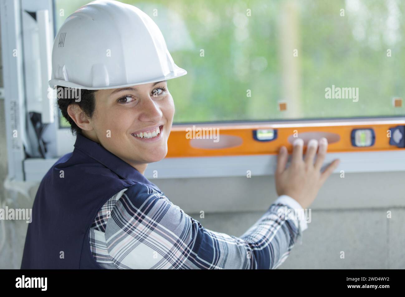 woman using spirit level on a window Stock Photo - Alamy