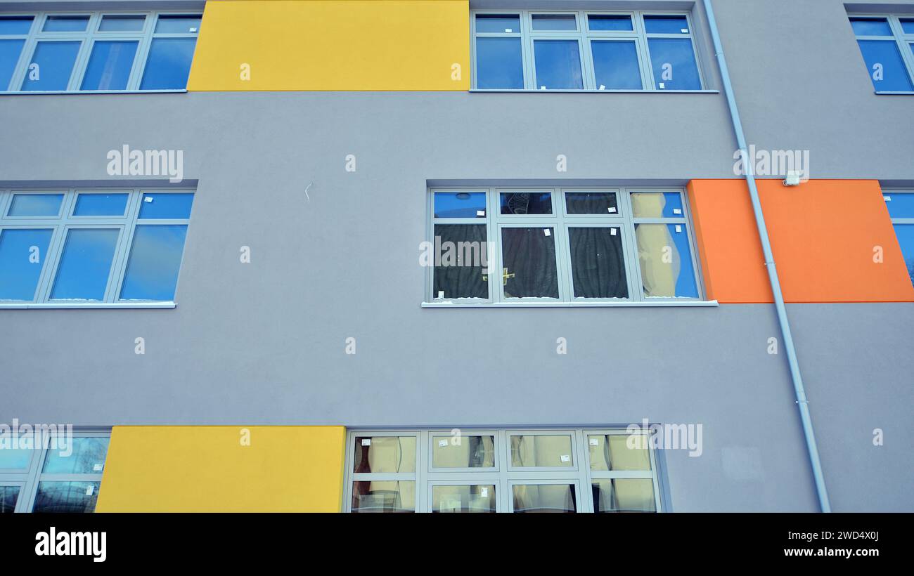 Multi-colored facades of the school with white window frames Stock ...