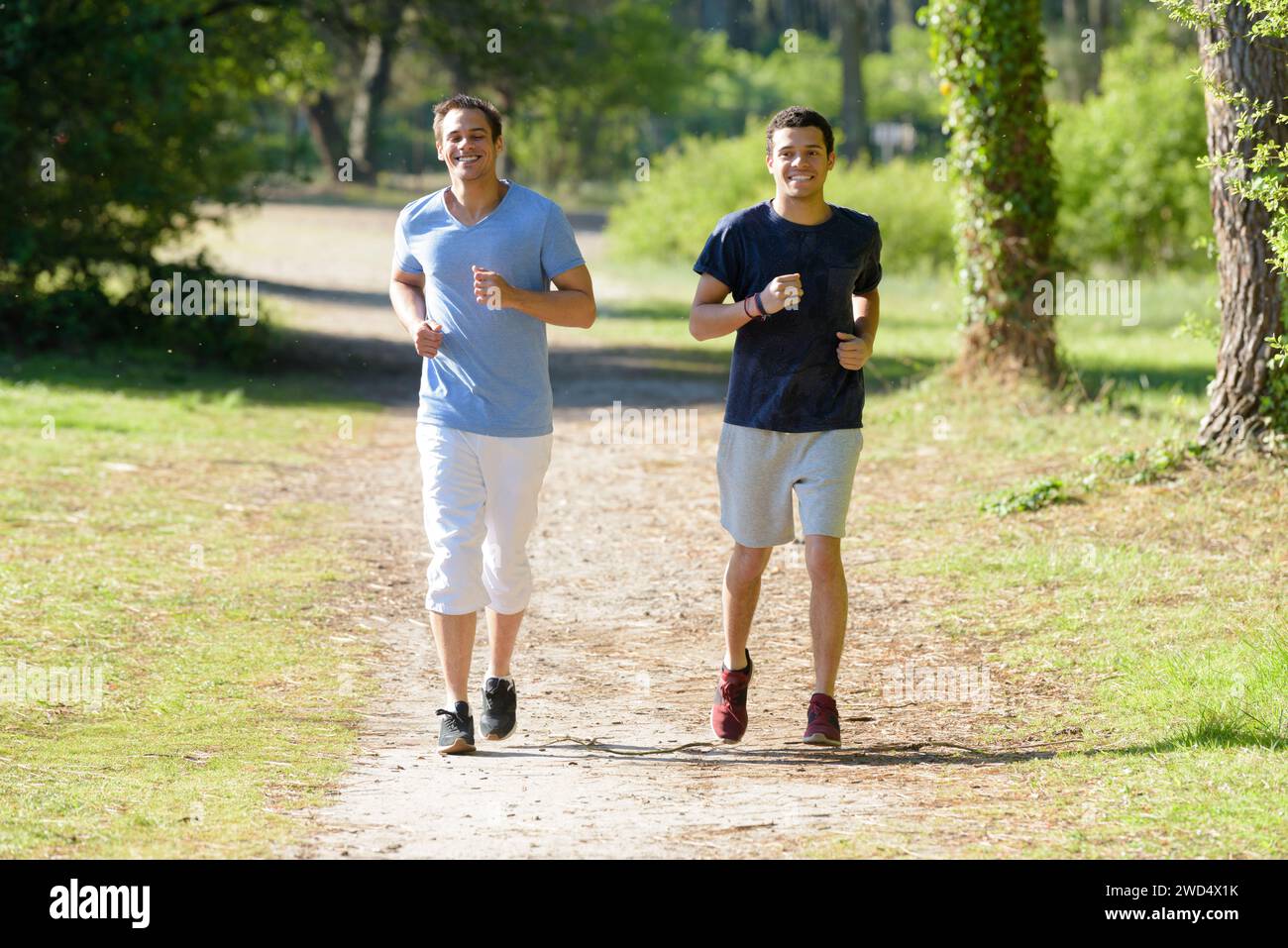 Sportive men running together outdoors hi-res stock photography and ...