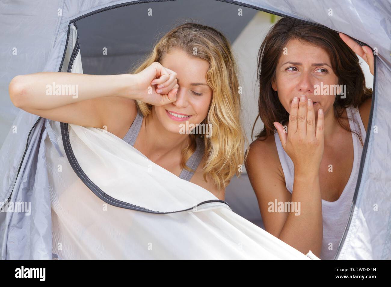walking up girls waking up in a tent camping Stock Photo - Alamy