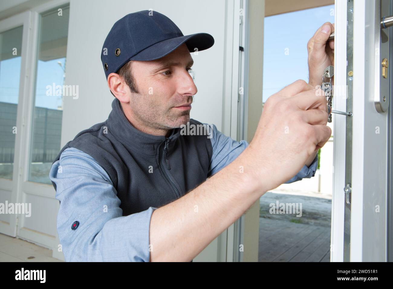 handyman adjusting door Stock Photo - Alamy