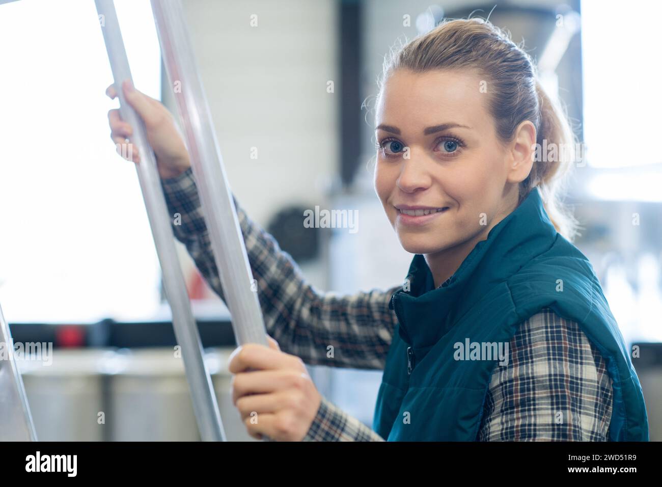 pretty female doing practical work at factory Stock Photo - Alamy