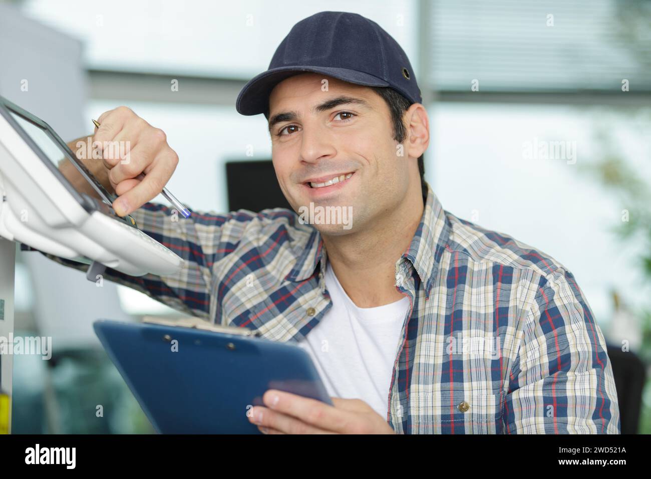 happy technician next to printer machine Stock Photo - Alamy