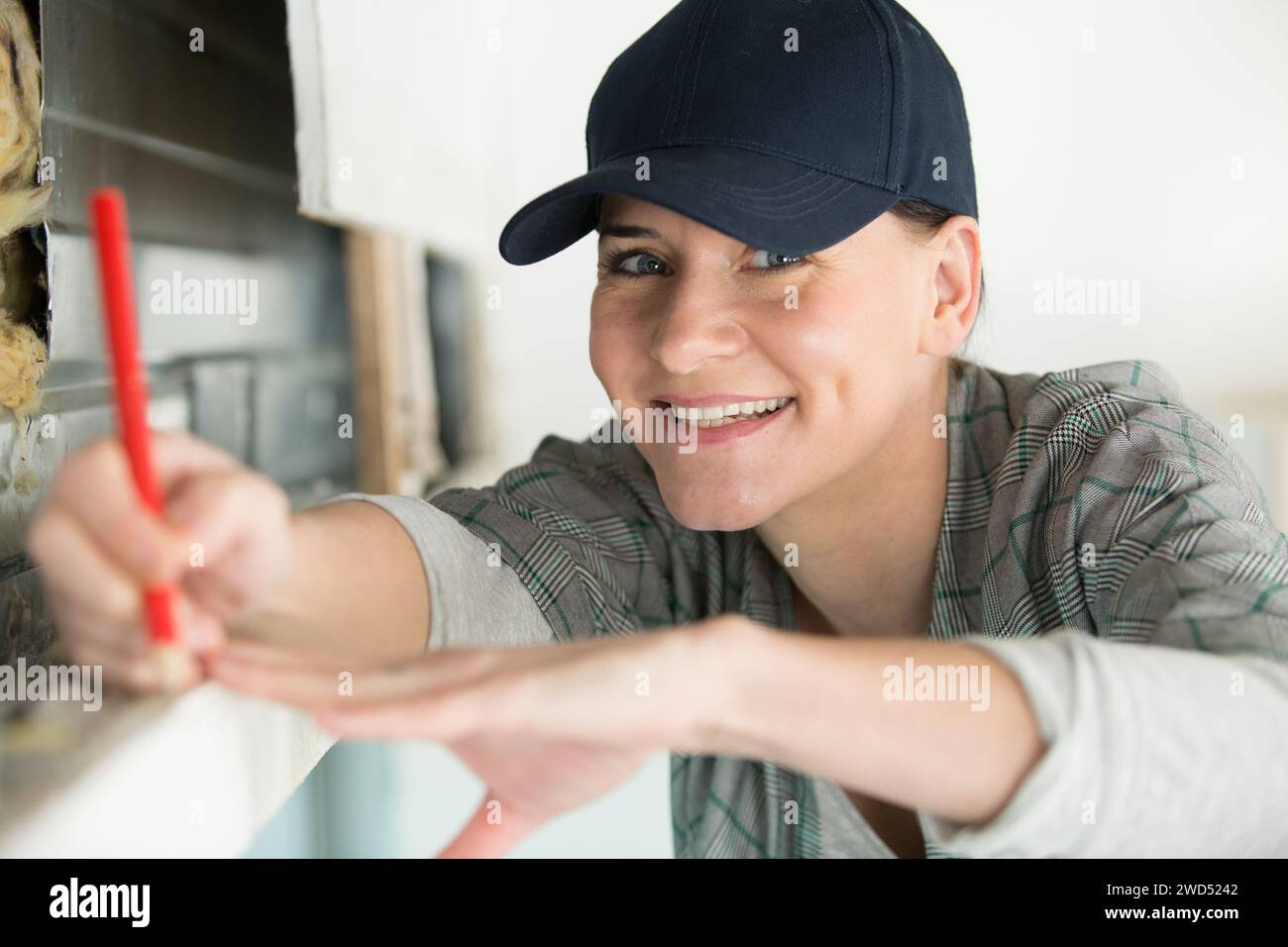 female worker marking something at work Stock Photo - Alamy