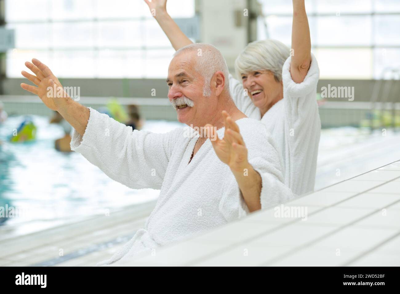 excited elderly couple beside a swimming pool Stock Photo - Alamy