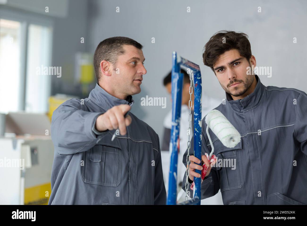 painting apprentice holding a roller brush Stock Photo - Alamy