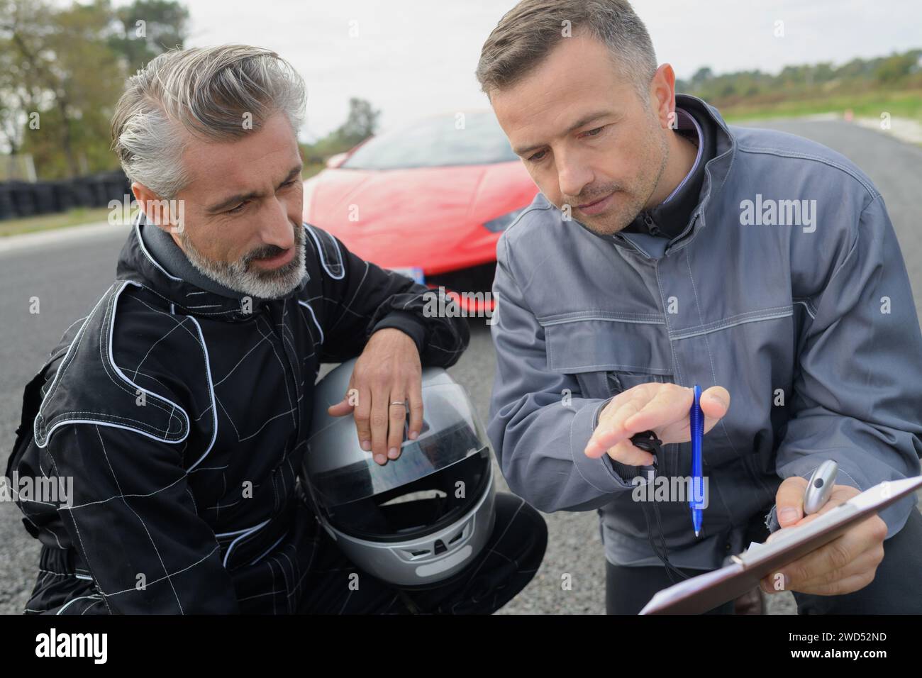 driver and coach analysing the race Stock Photo - Alamy