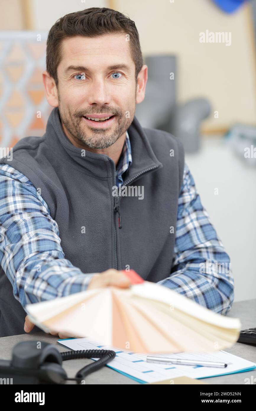 man showing colour swatches in his office Stock Photo - Alamy