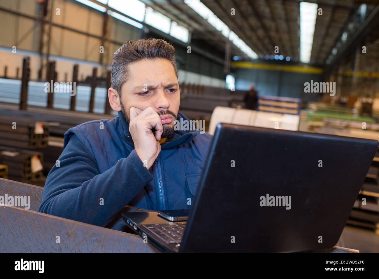 warehouse manager using computer in a warehouse Stock Photo - Alamy